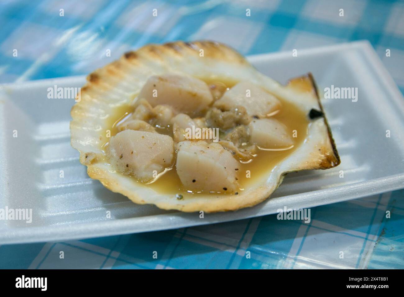 Seafood shell and fish cooked on a grill at the Osaka fish market in ...