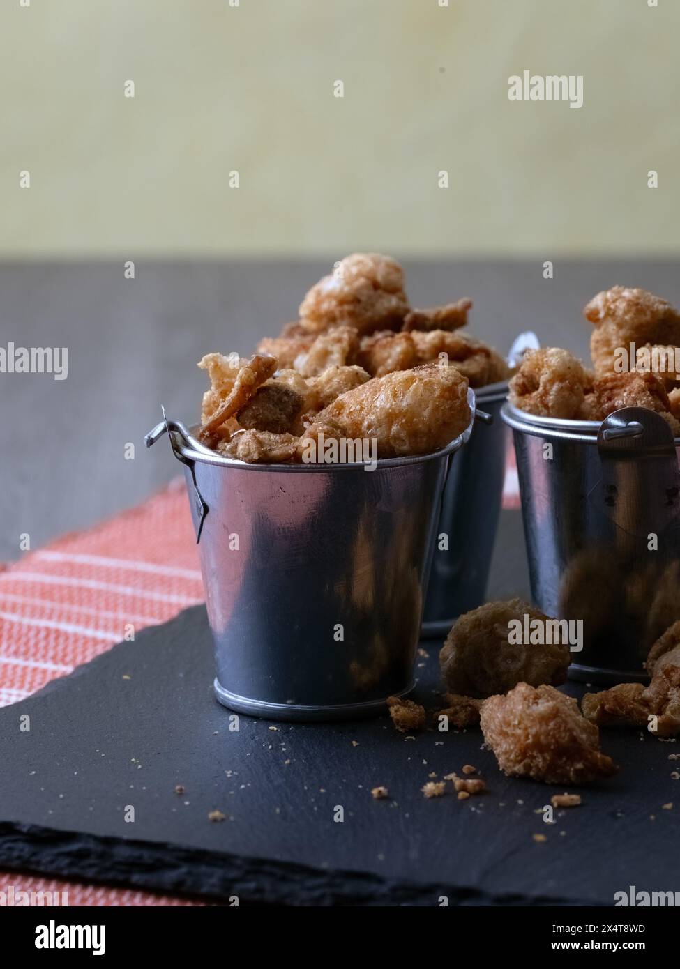 Snack of salted pork rind scratchings in miniature buckets Stock Photo ...