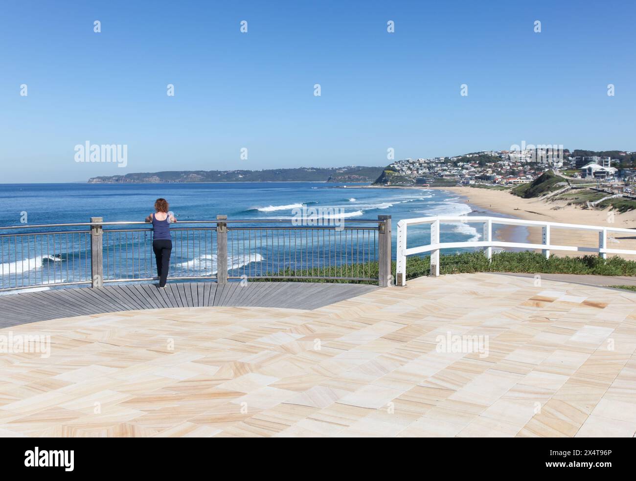 A women enjoys the view from a lookout over Bar Beach and Merewether ...