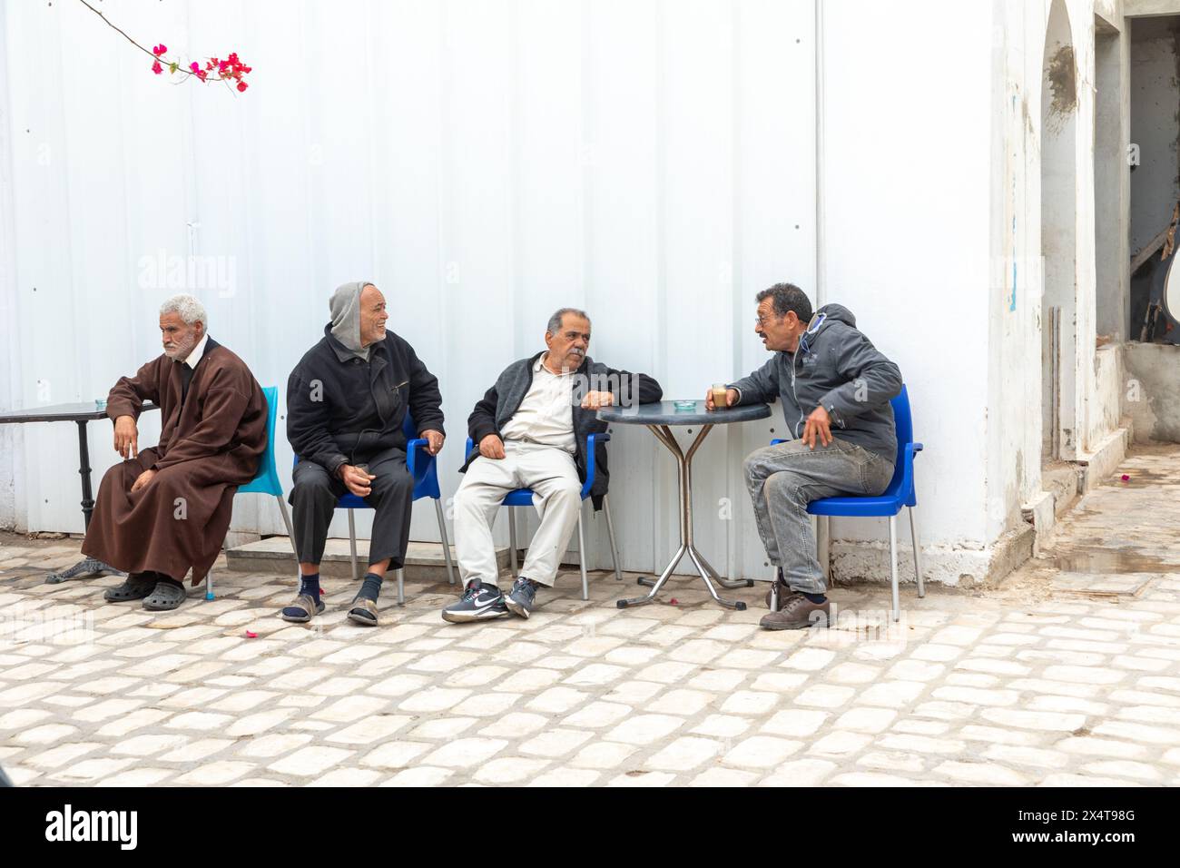 Houmt El Souk, Tunesia - April 30, 2024: arabic men sitting in front of ...