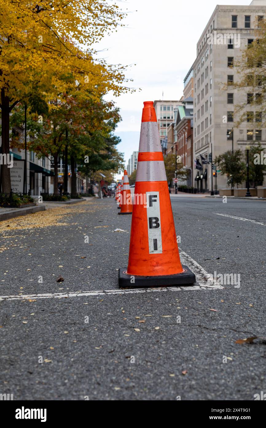Orange cone labelled FBI on a street in Washington DC, USA. No cars or ...