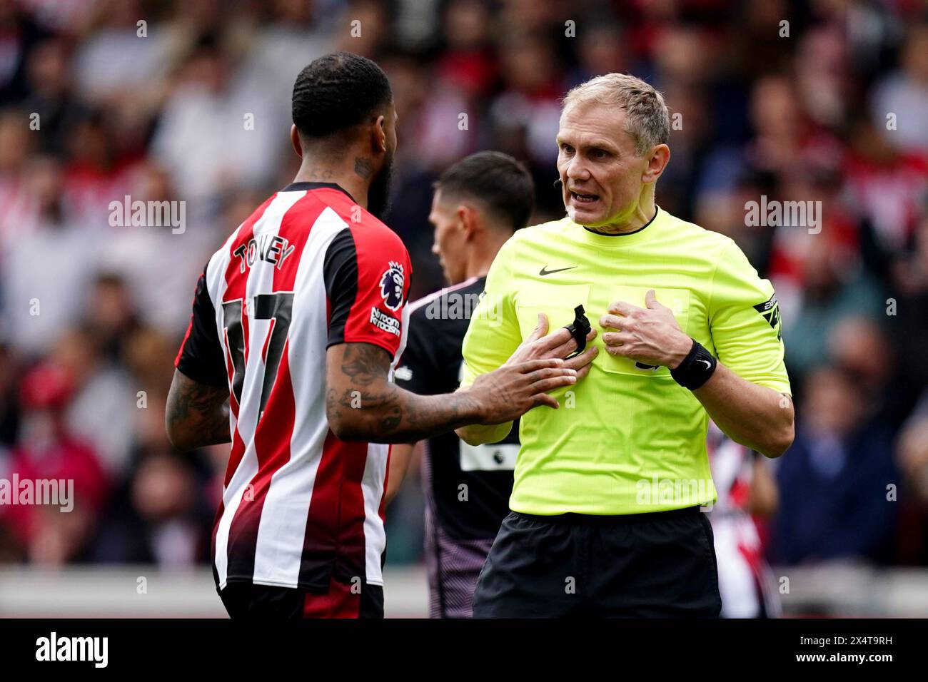 Referee Graham Scott, (right) explains a decision to Brentford's Ivan ...