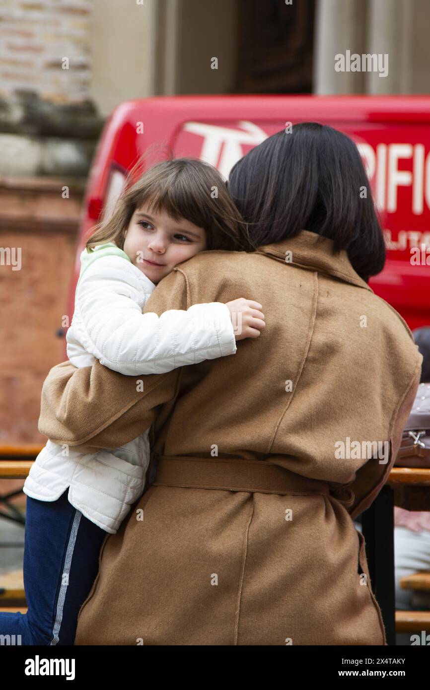 Back view of mom embracing child Stock Photo - Alamy