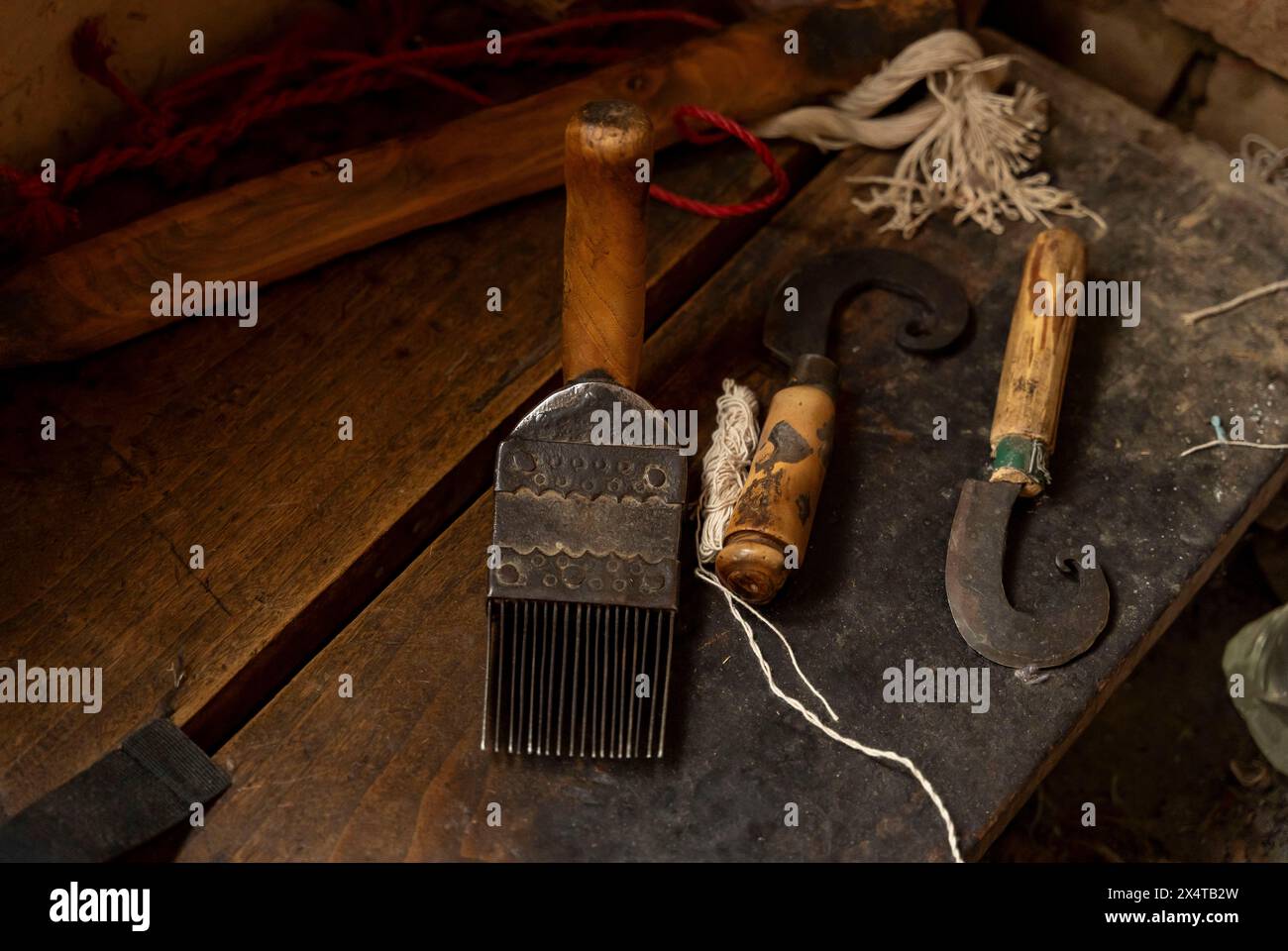 Tools used in carpet weaving are seen placed near a loom inside a ...