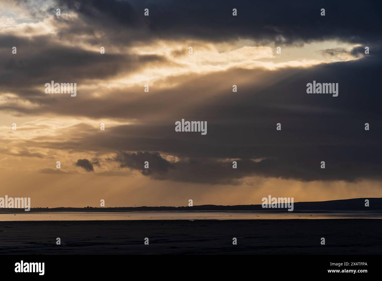 Stunning dramatic stormy skies over ocean landscape with distant heavy ...