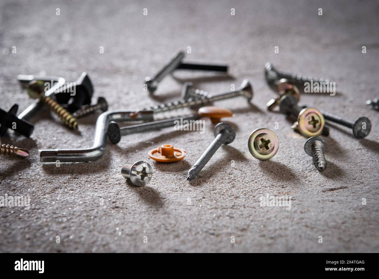Screw, nail on concrete texture background. Closeup of screws and nails ...