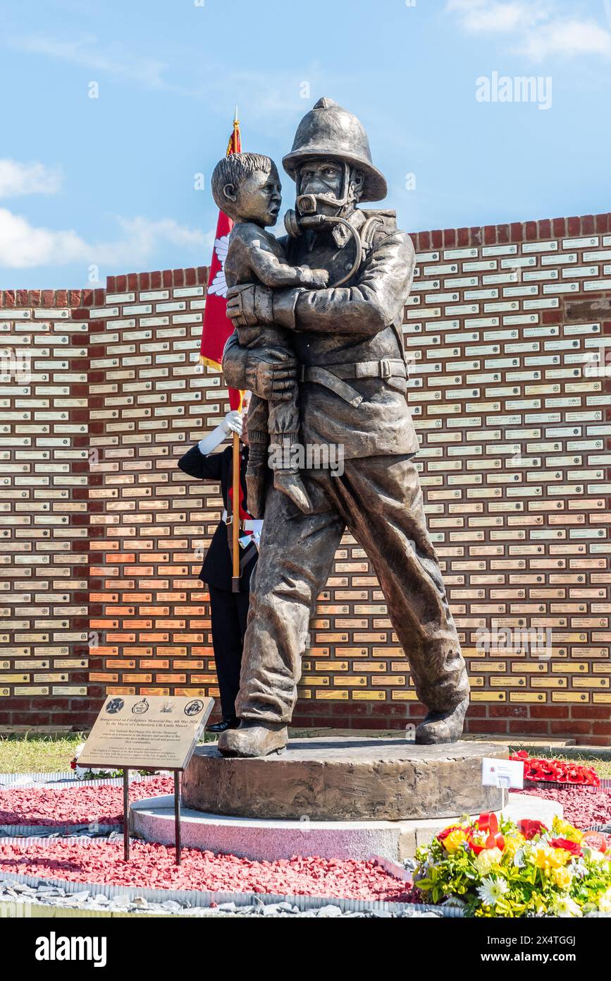 Firefighter statue, rescuing a child, at the unveiling and opening of ...