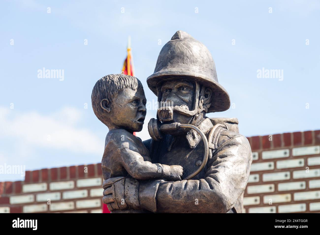 Firefighter statue, rescuing a child, at the unveiling and opening of ...