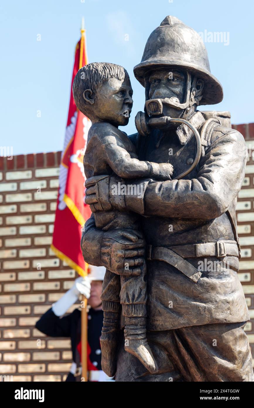 Firefighter statue, rescuing a child, at the unveiling and opening of ...
