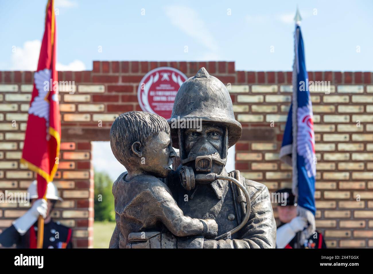 Firefighter statue, rescuing a child, at the unveiling and opening of ...