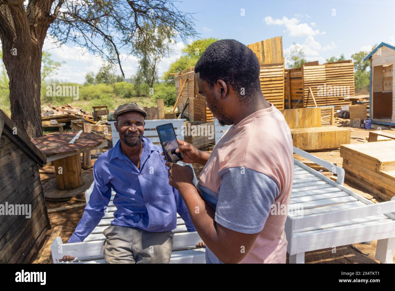 ngo social worker taking pictures with the smartphone of a small ...