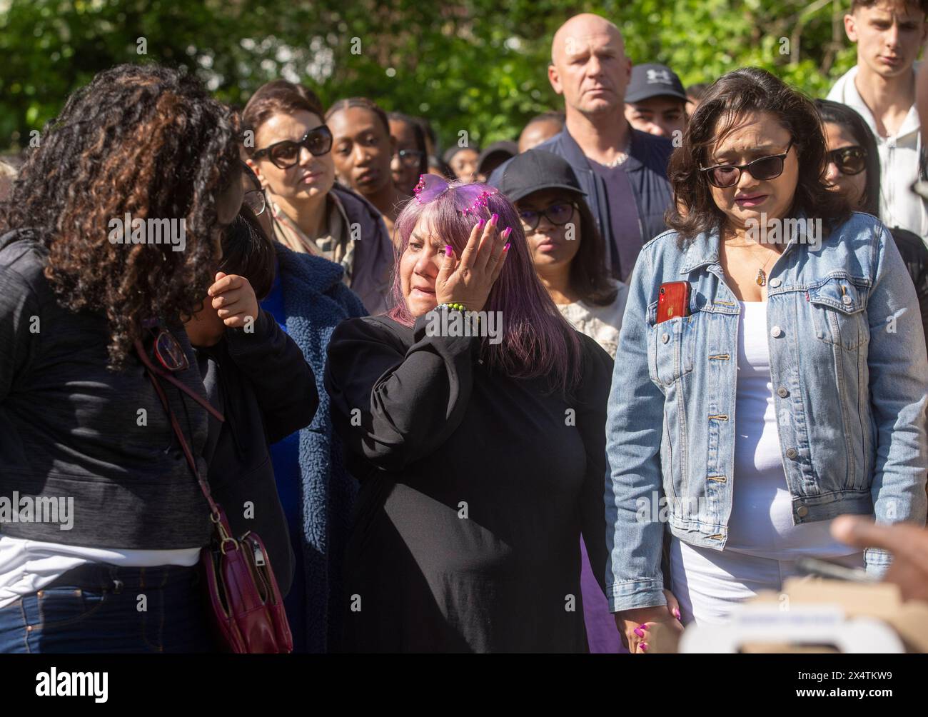 People attend a vigil at Hainault Underground Station Car Park, north ...