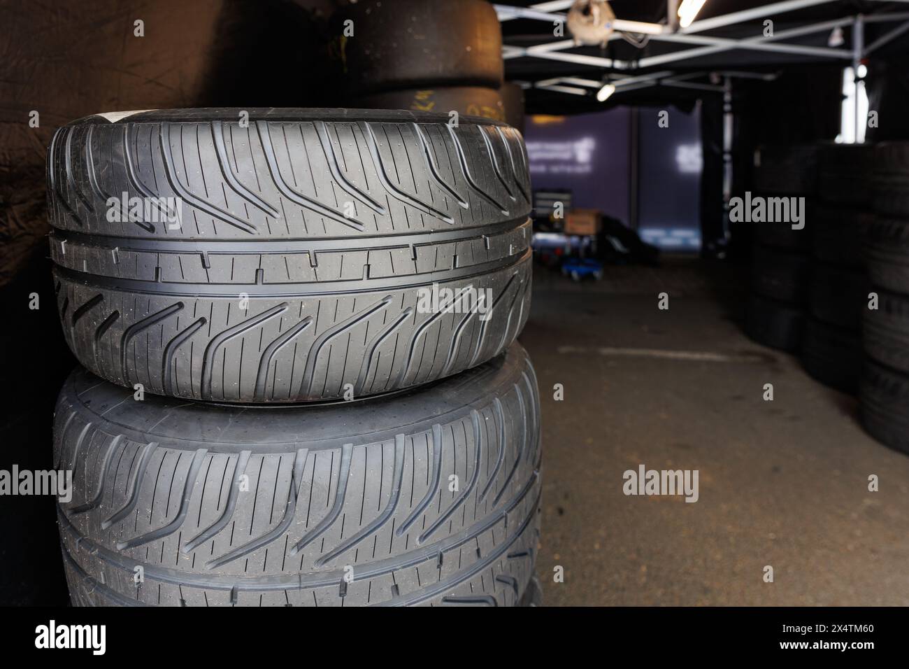 Sport racing tires wheels set ready to mount at paddock pits area at ...