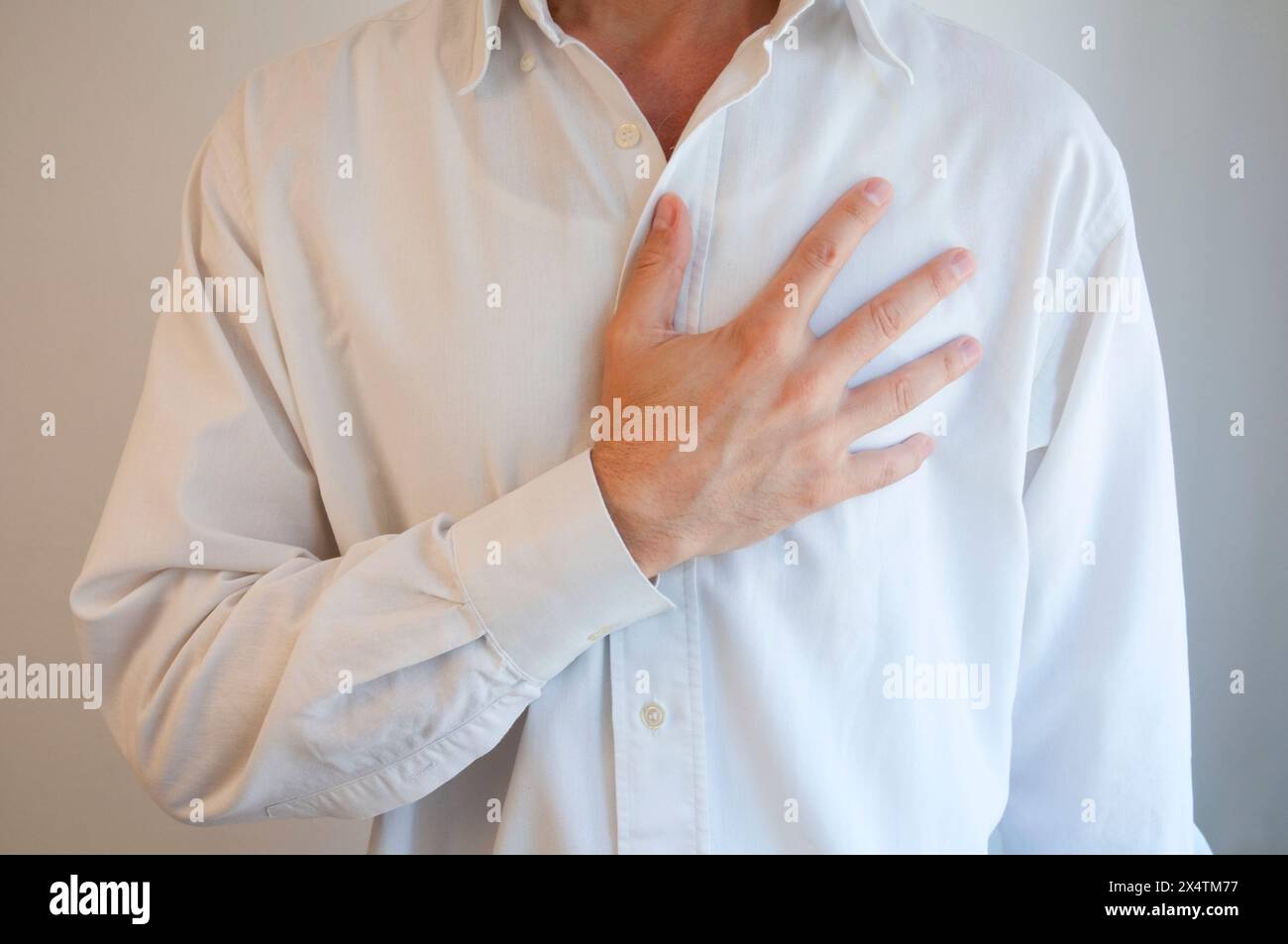 Man with his hand on heart Stock Photo - Alamy