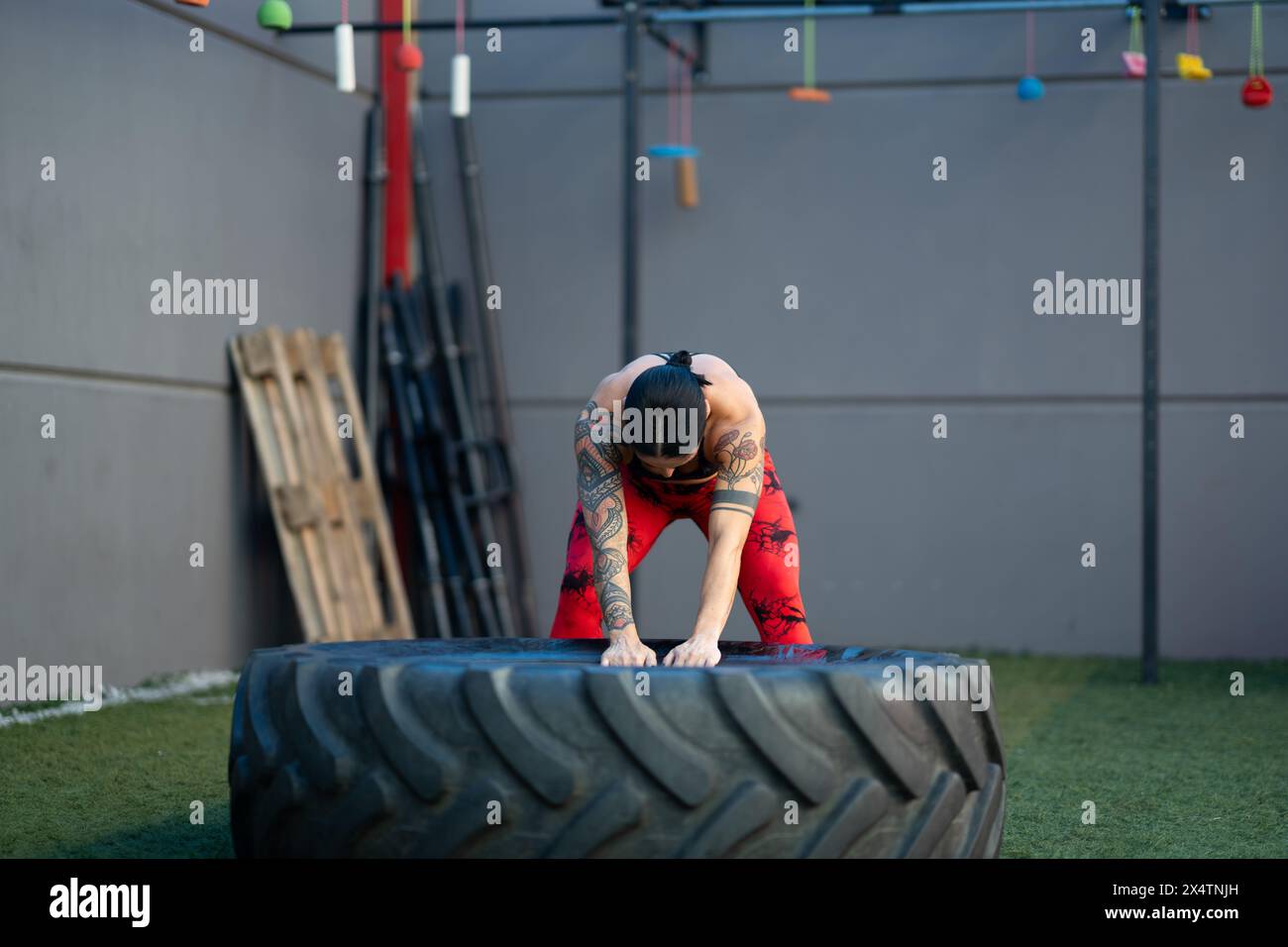 Strong mature woman training using huge wheel in a gym Stock Photo - Alamy