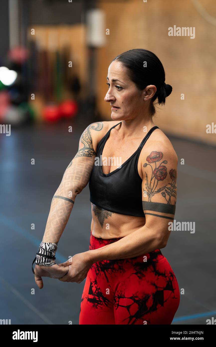 Woman stretching arms after working out in a gym Stock Photo - Alamy