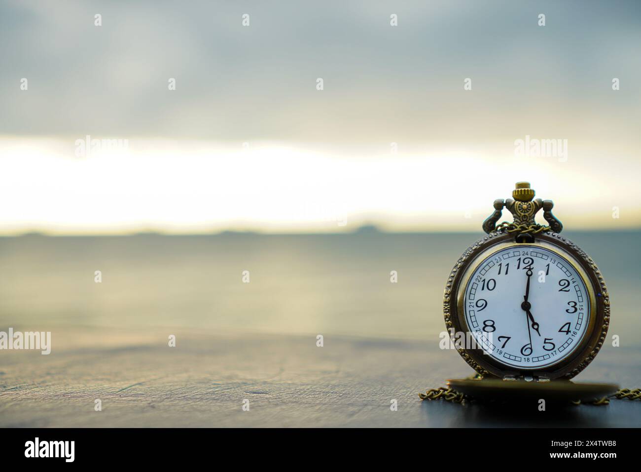 Vintage gold pocket watch with blur background and copy space for text ...