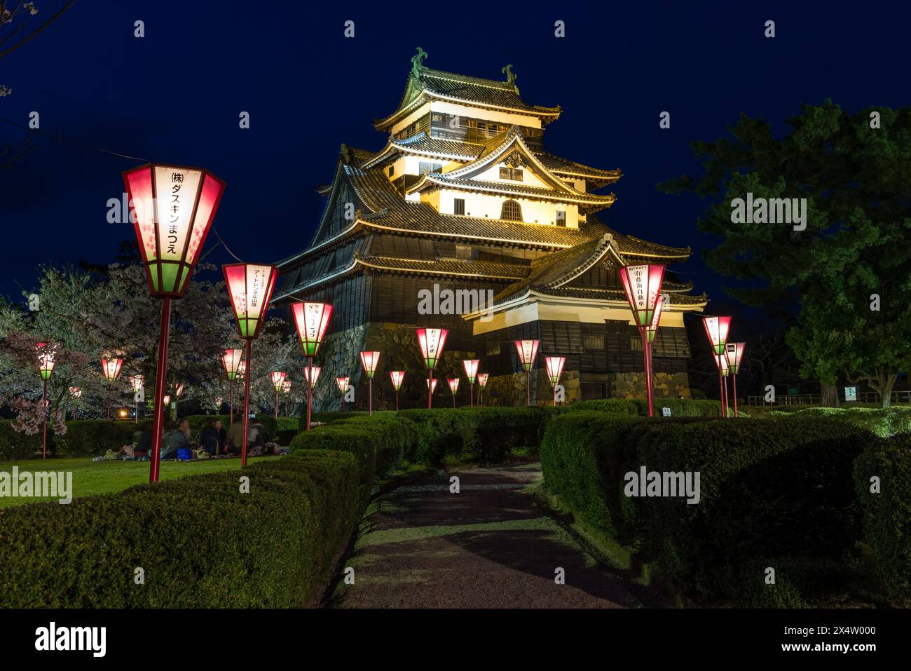 A large building with red lanterns lit up at night. The lanterns are ...
