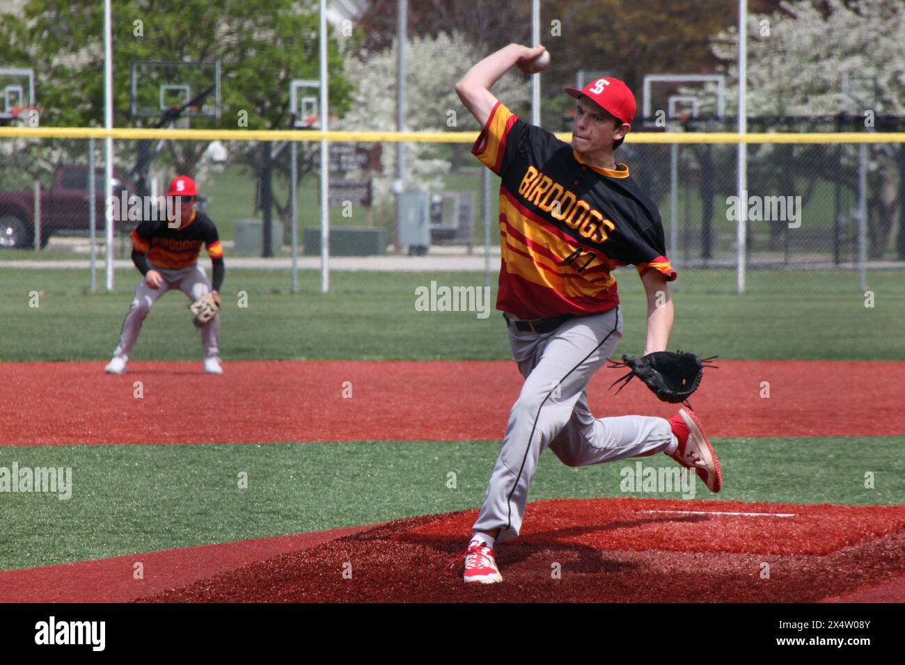 pitcher delivering at high school baseball game Stock Photo - Alamy
