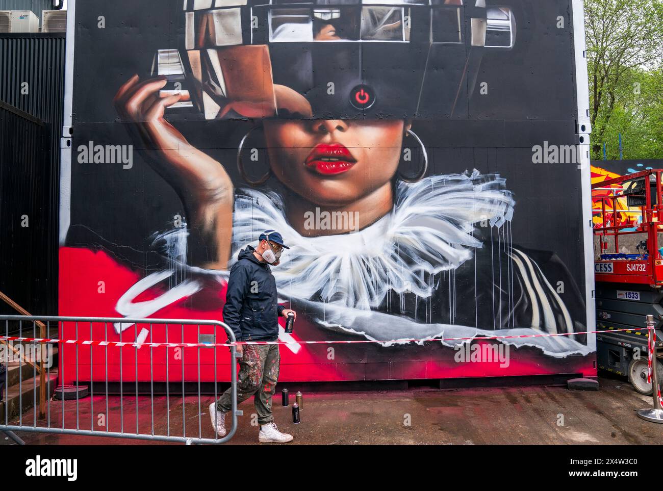 Artist 'epod3000' alongside his work at the Yardworks Festival 2024 in ...