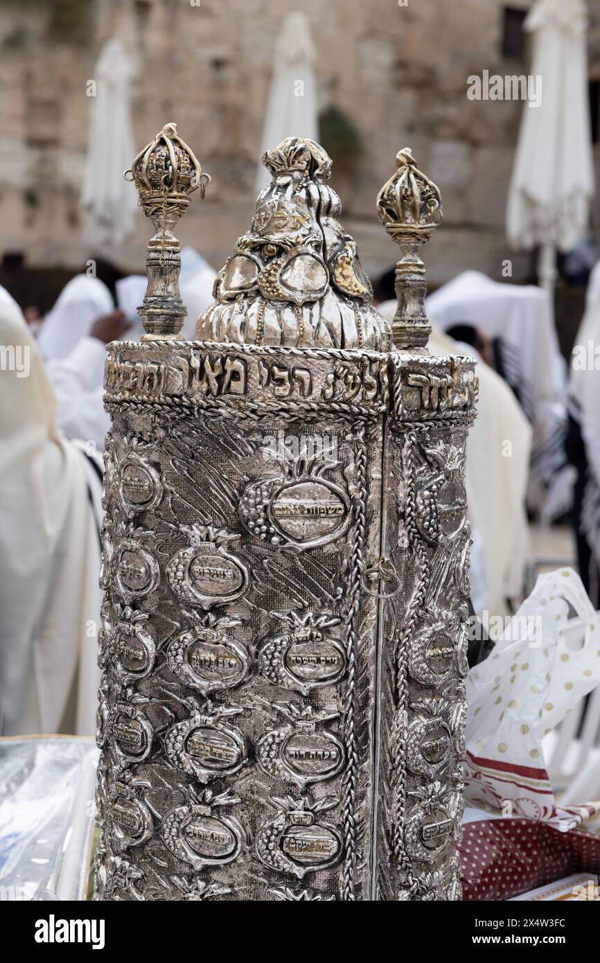 An ornate, decorative, silver, Sephardic-style case holding the Torah ...