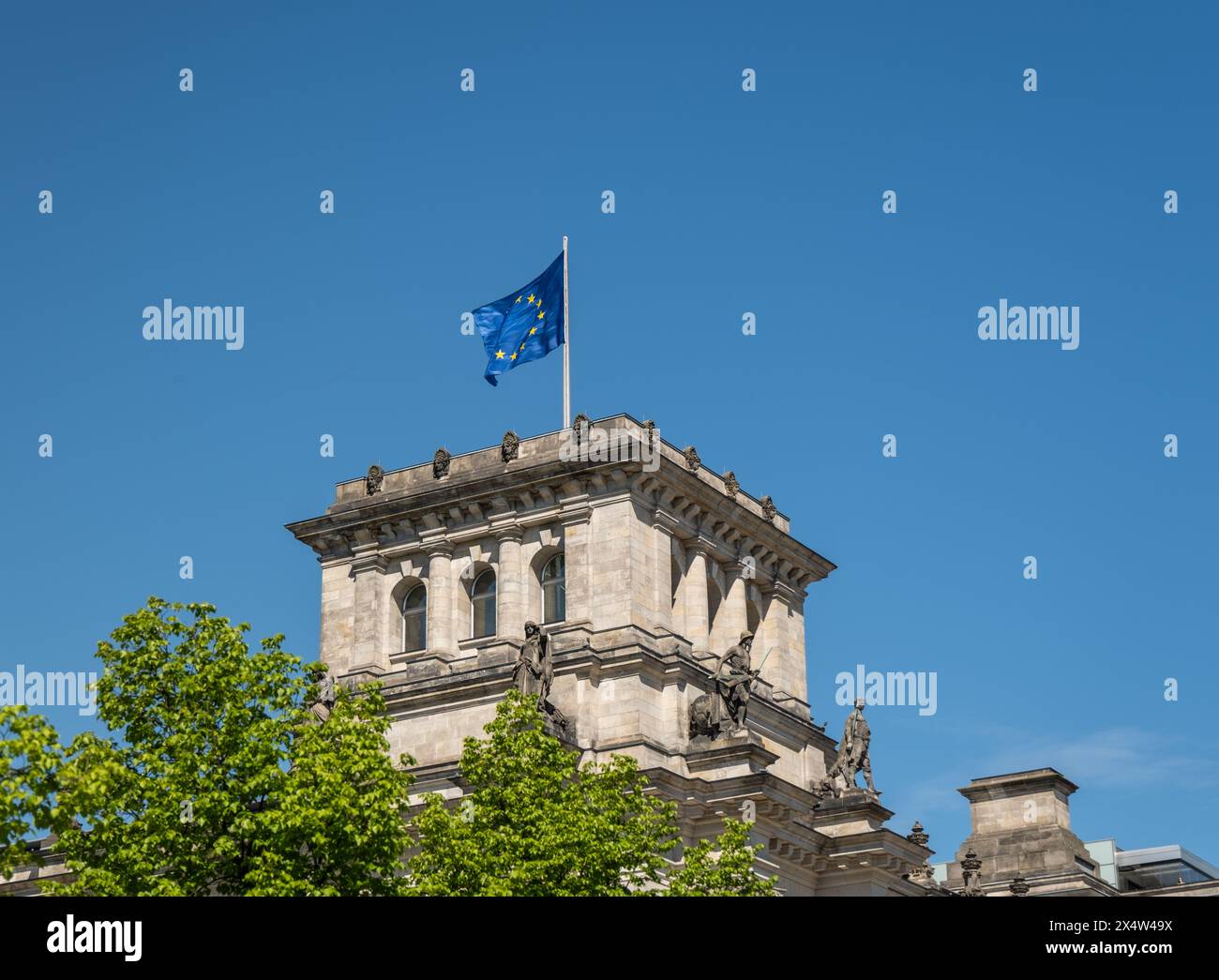 European Union flag waving above the German Parliament building ...