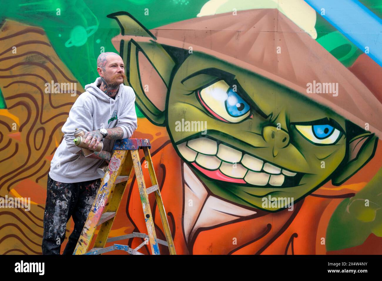Artist Reckless, from Aberdeen, alongside part of his mural at the ...
