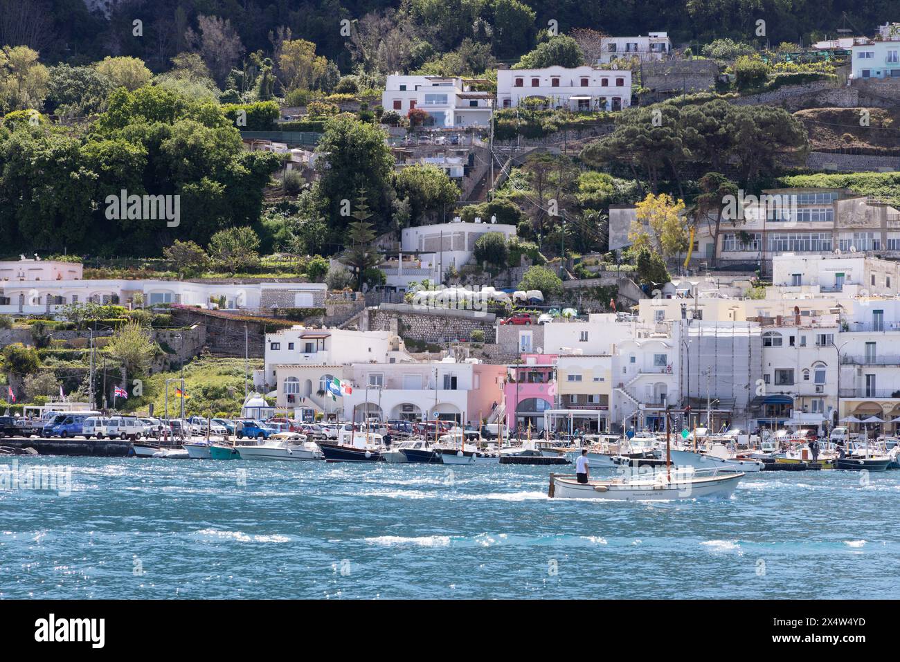Capri Italy; Capri harbour, waterfront and town in sunshine in Spring ...