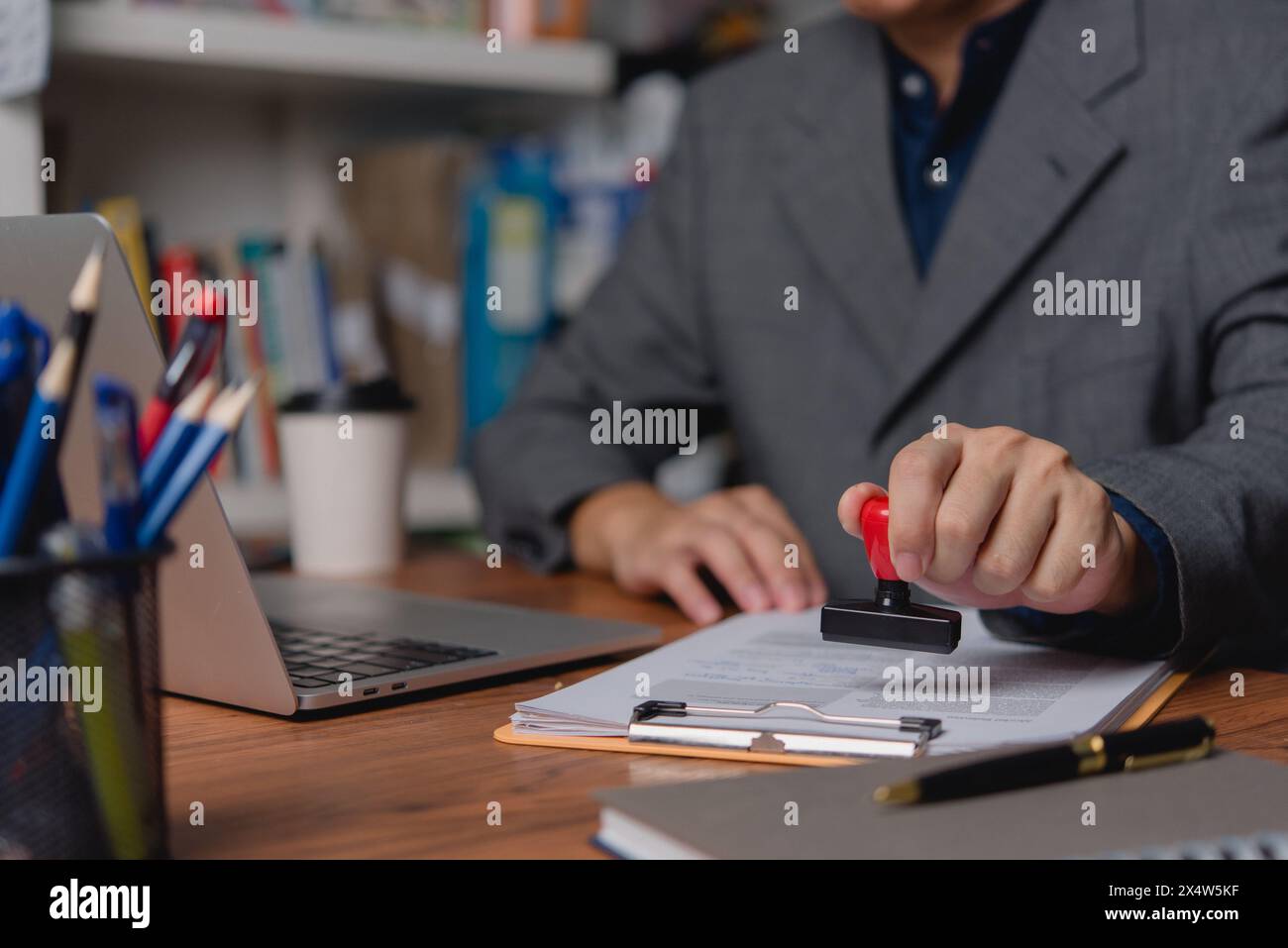 A professional applies an official seal to company documents ...