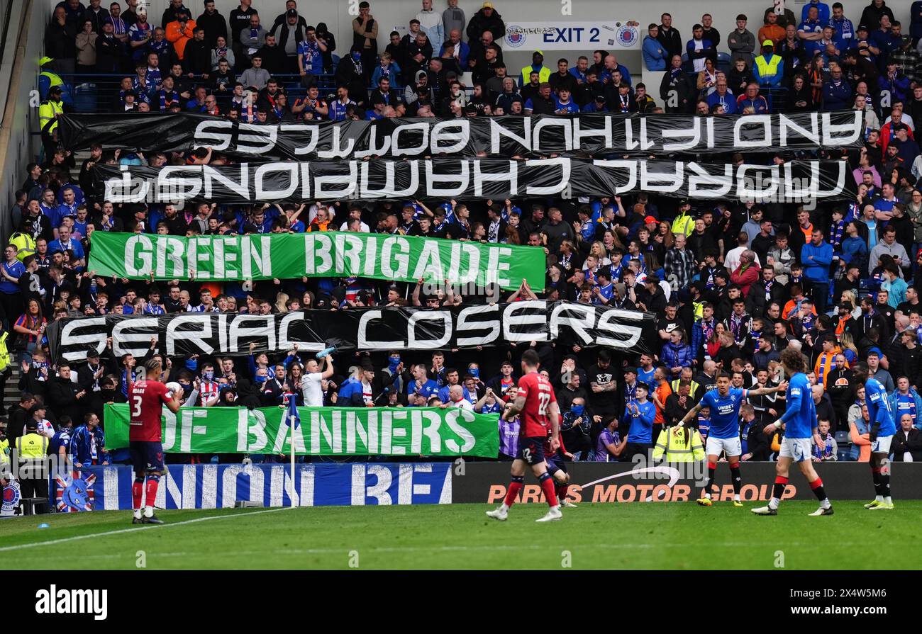 Rangers fans hold up upside down banners aimed at Celtic fans during ...
