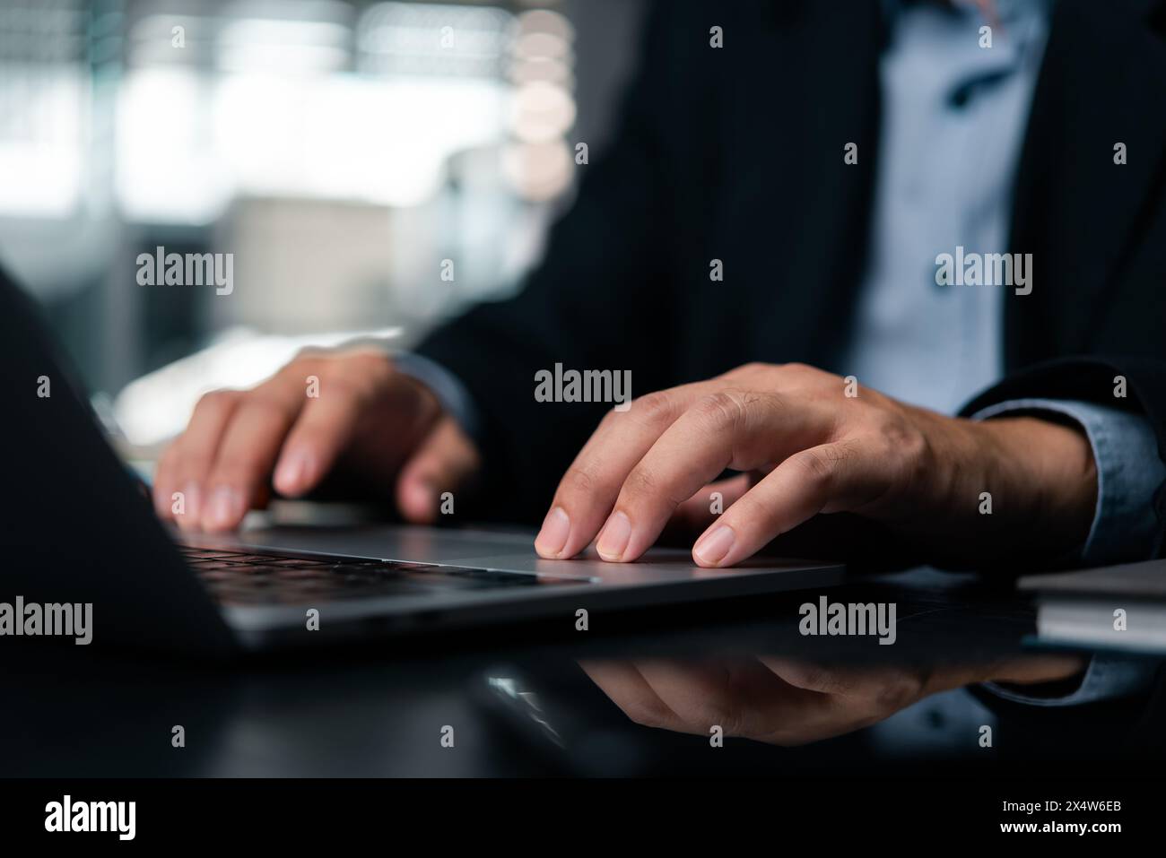 Close-up hand professional man typing keyboard on a modern laptop computer work at office ...