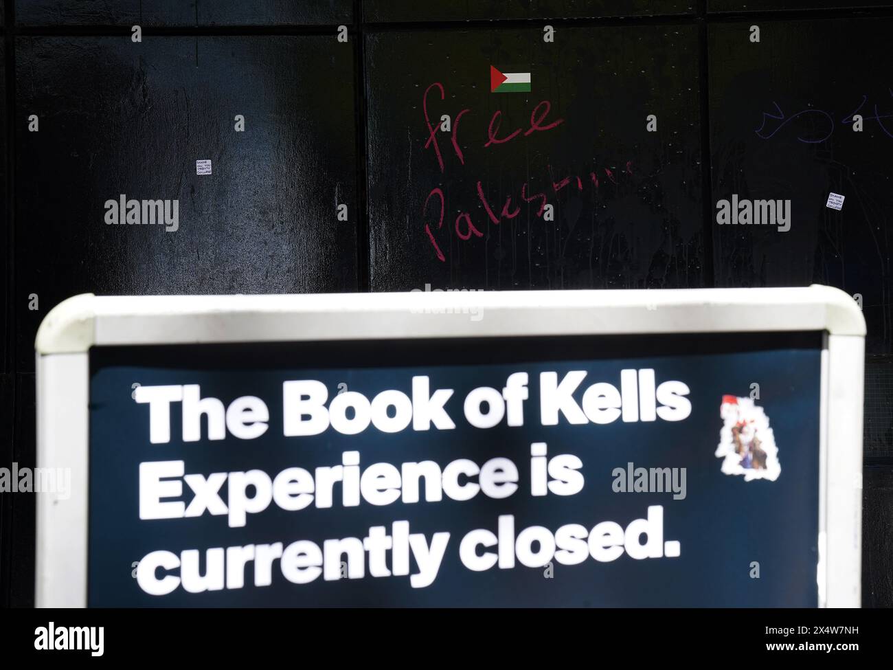 Pro-Palestine graffiti on a gate at an entrance to Trinity College in ...