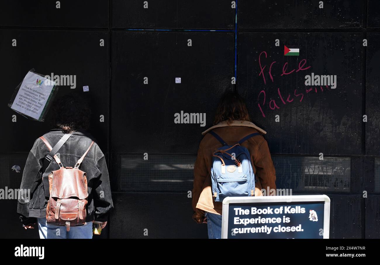 Pro-Palestine graffiti on a gate at an entrance to Trinity College in ...