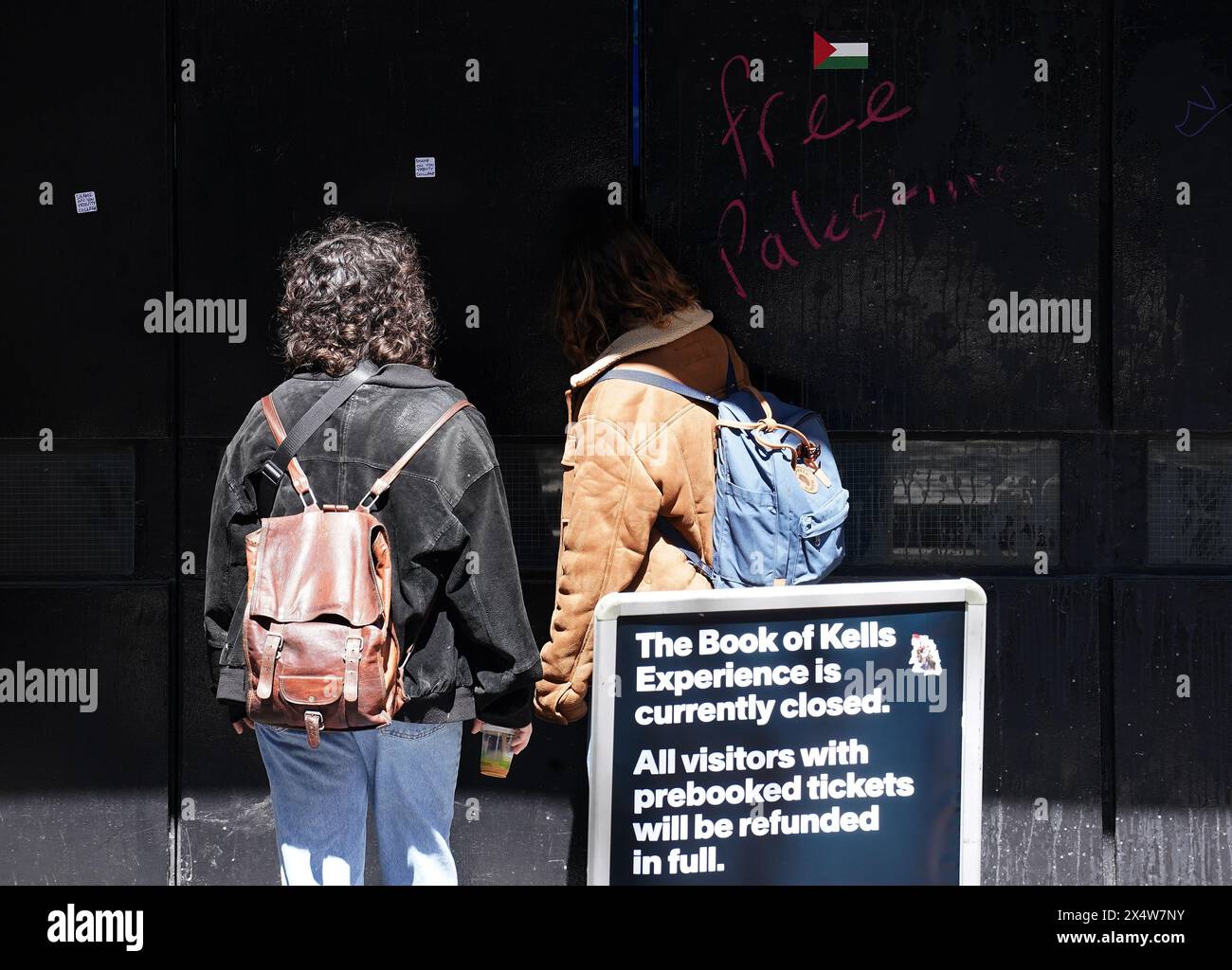 Pro-Palestine graffiti on a gate at an entrance to Trinity College in ...