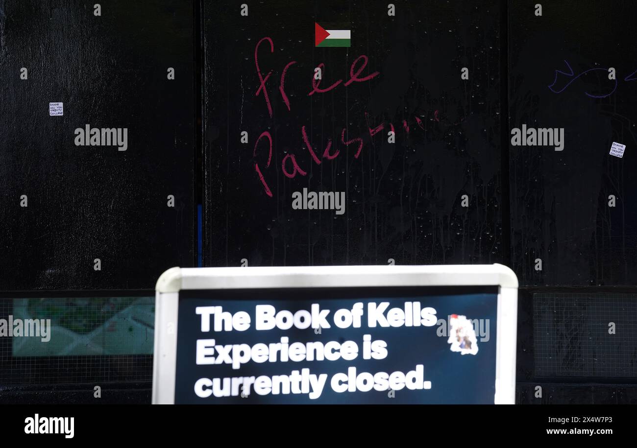 Pro-Palestine graffiti on a gate at an entrance to Trinity College in ...