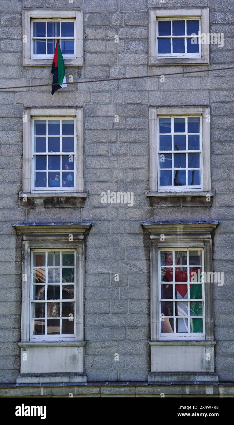 Palestine flags hang from windows of Trinity College in Dublin. The ...