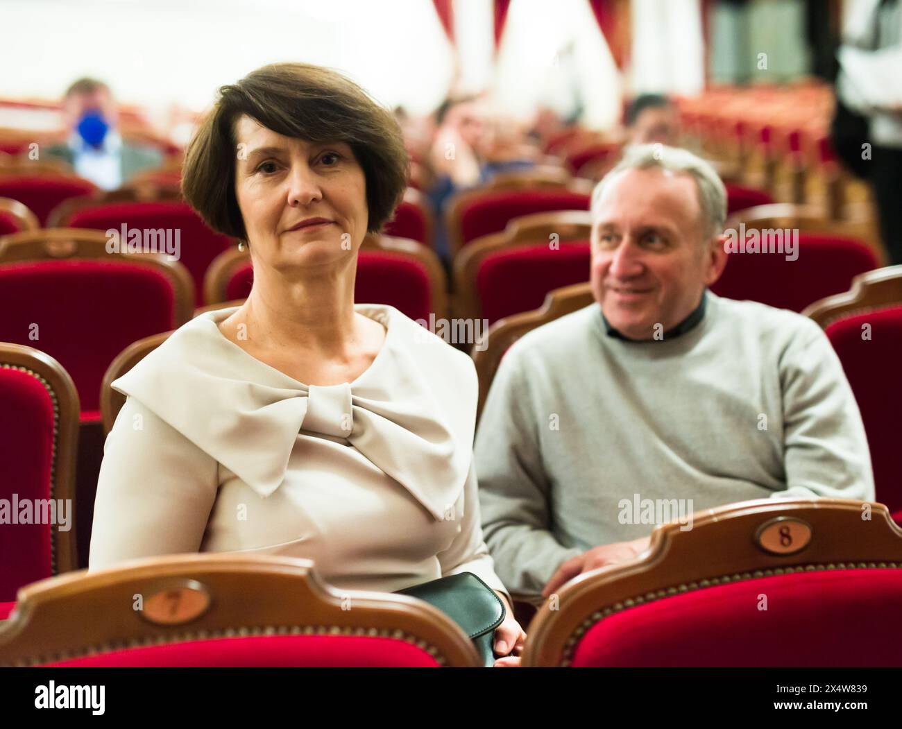Elderly couple watching play in the theater Stock Photo - Alamy