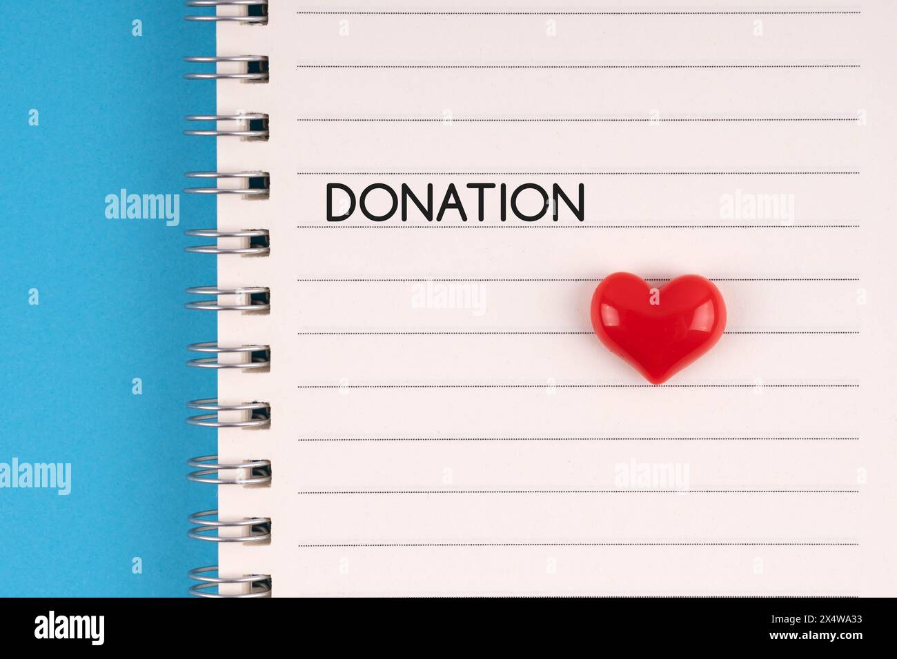 Heart shape on notepad with text donation Stock Photo - Alamy