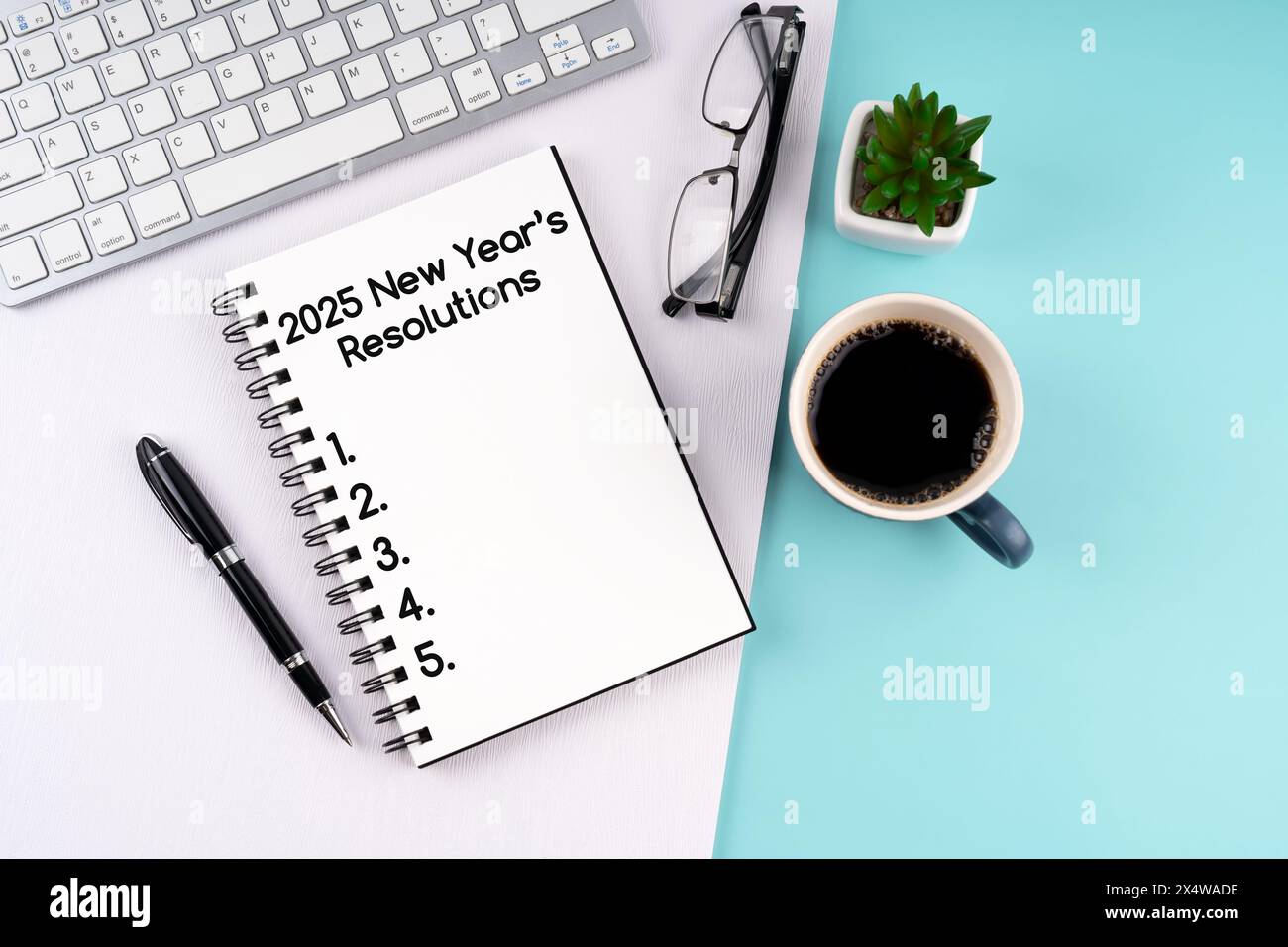 High angle view of 2025 New Year's Resolutions text on notepad Stock ...