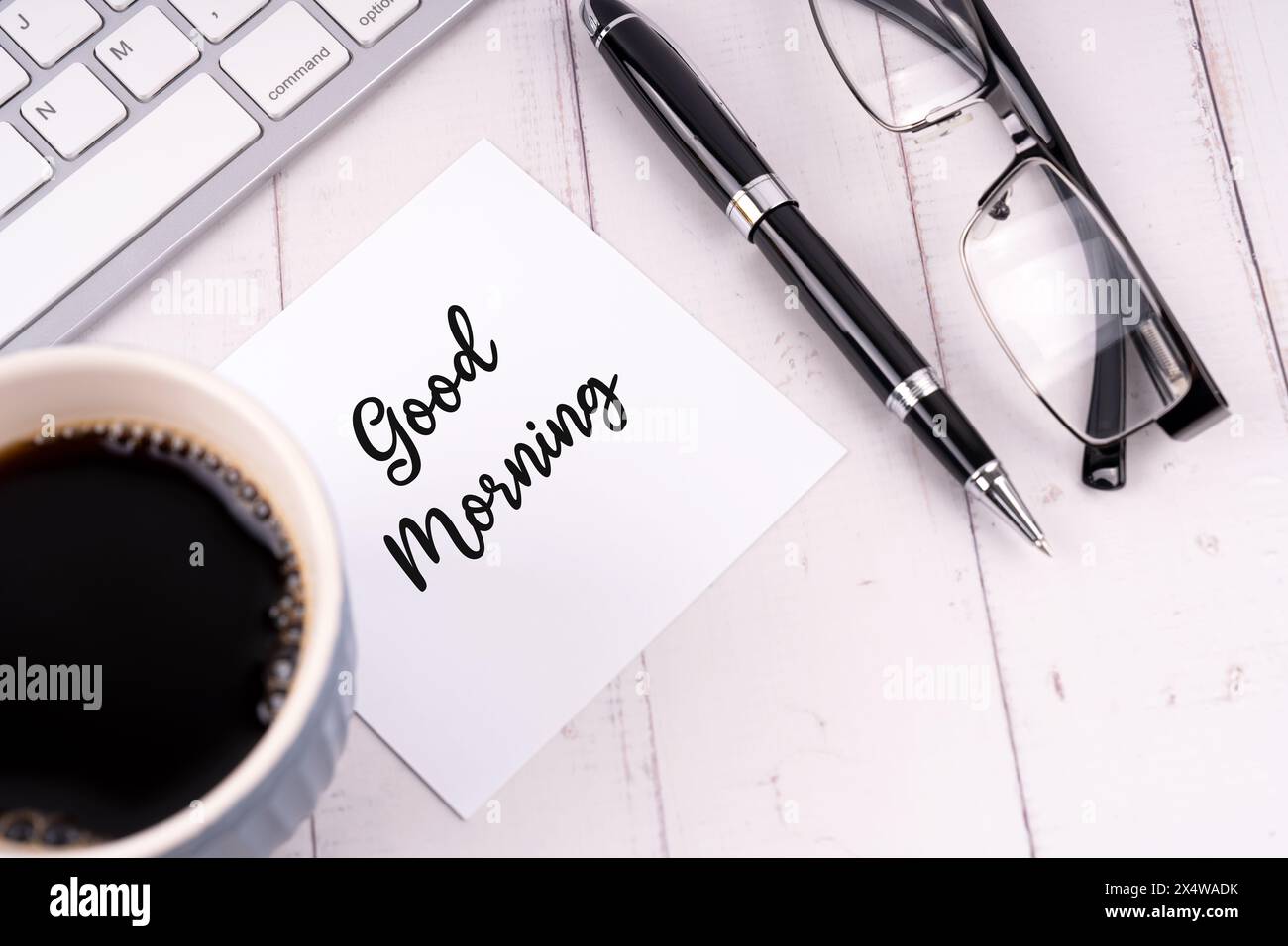 Cup of coffee and good morning note on a desk Stock Photo - Alamy