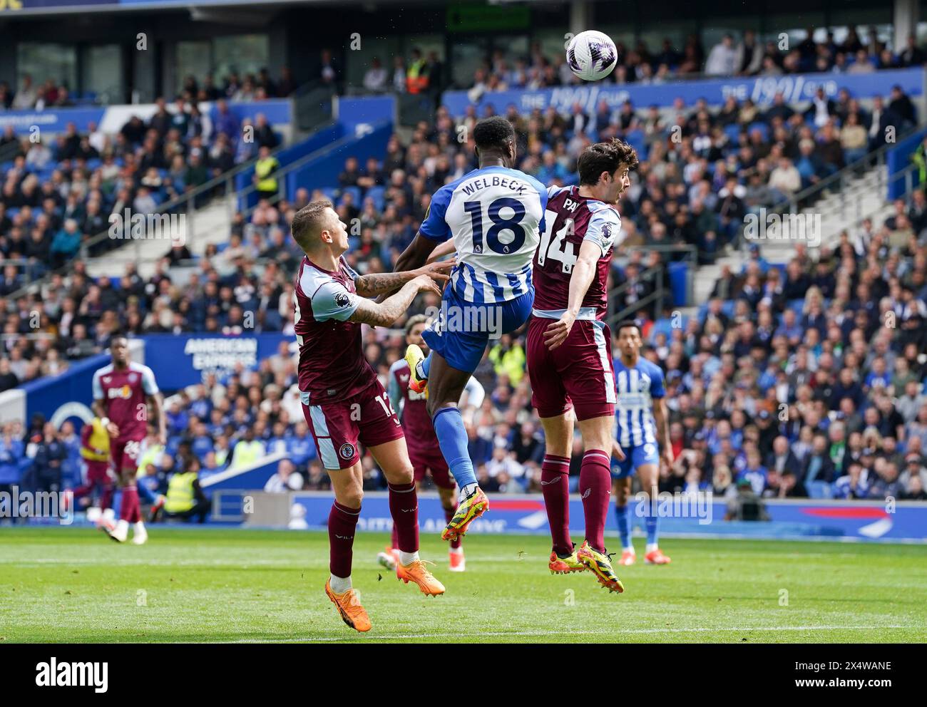 Brighton and Hove Albion's Danny Welbeck (centre) attempts a header ...