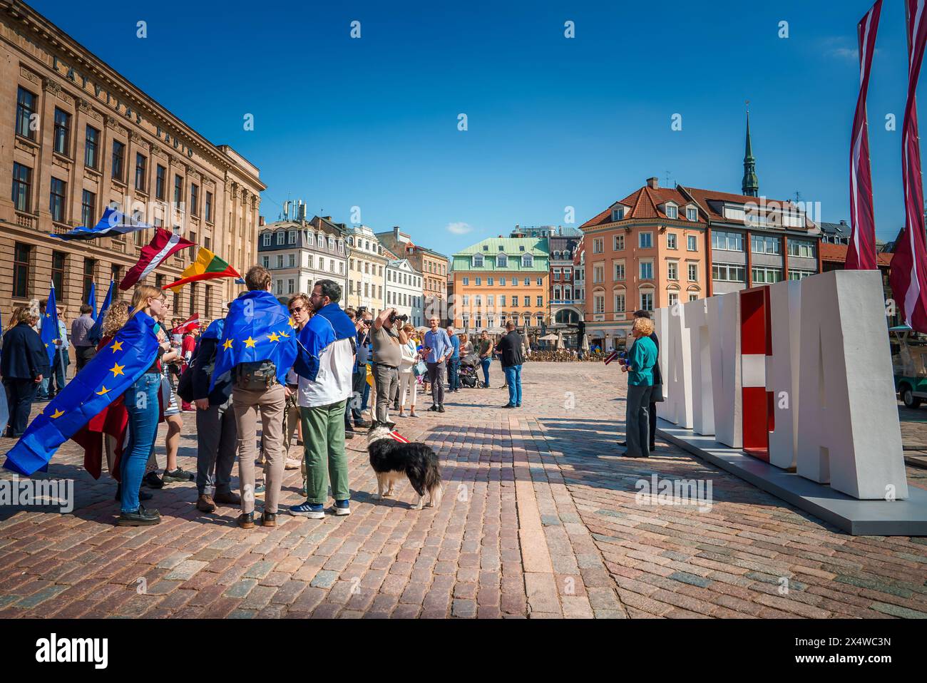 Sunny day in Riga, Latvia with LATVIA letters in front, flag colors ...
