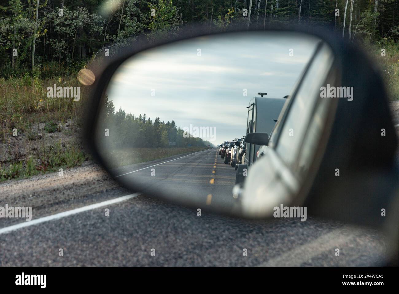 Convoy of vehicles along Highway 3 during wildfire evacuation of ...