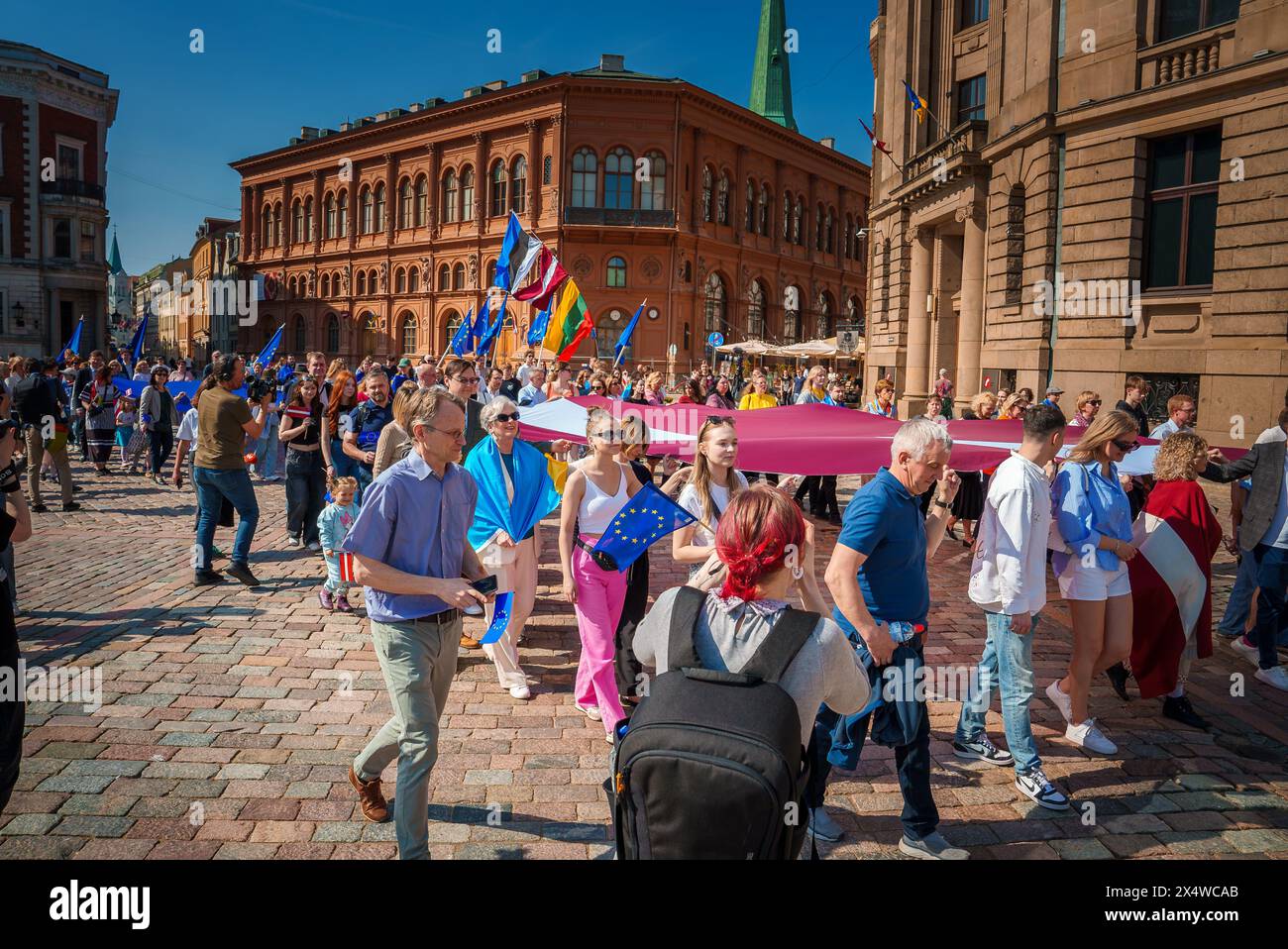 Vibrant celebration in Riga's old town square, Latvia Stock Photo - Alamy