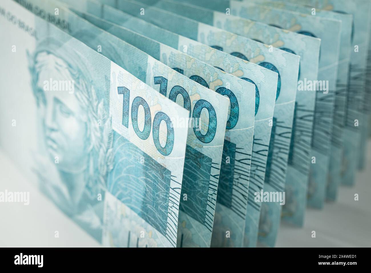 Brazil money, Stack of 100 reais banknotes standing in harmony ...
