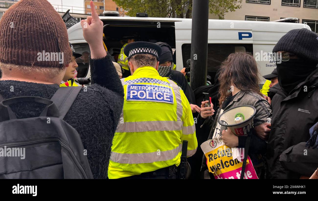 Protestors in Peckham face off with police during an immigration ...
