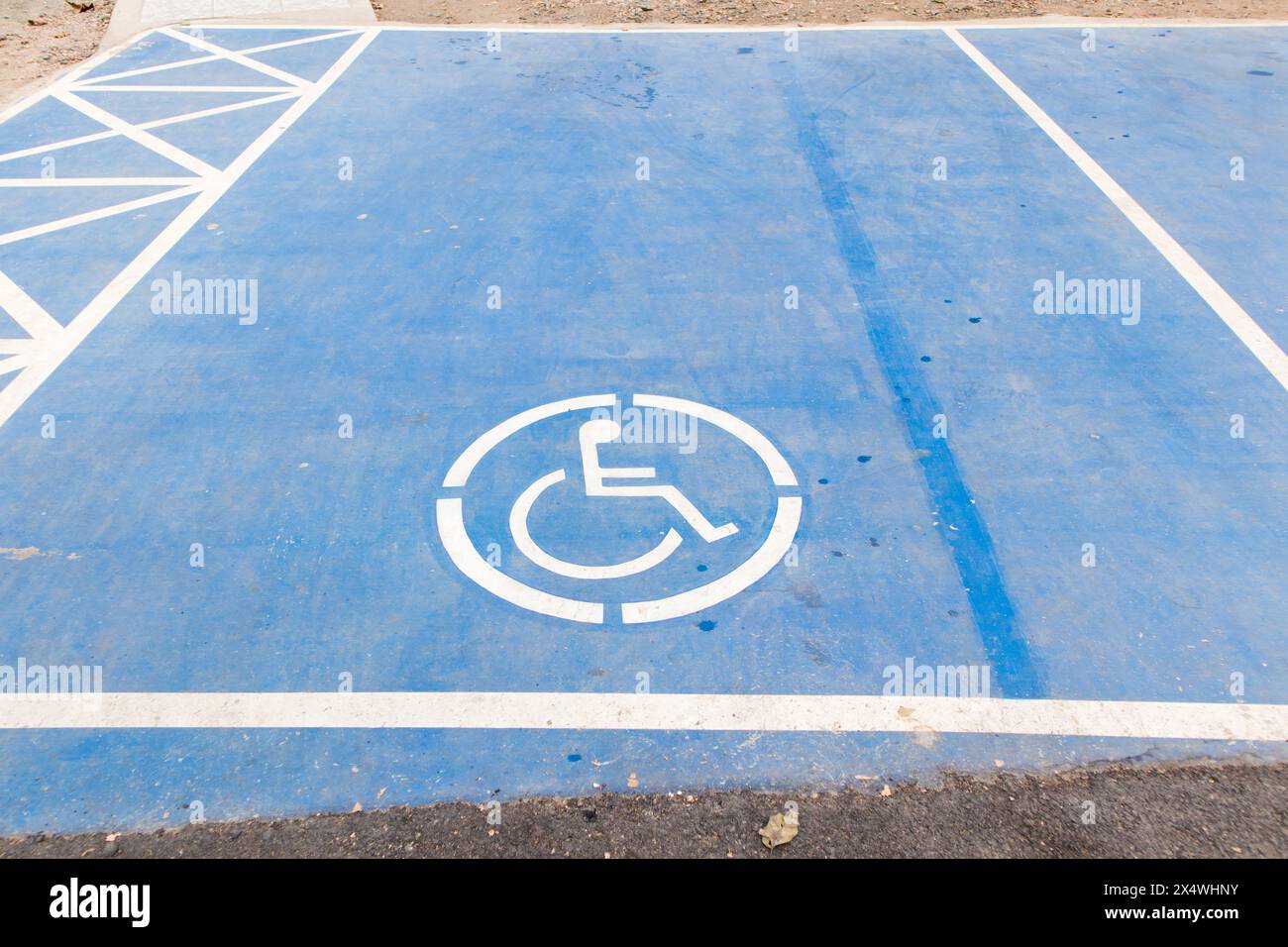 disable sign on blue paint color car park Stock Photo - Alamy