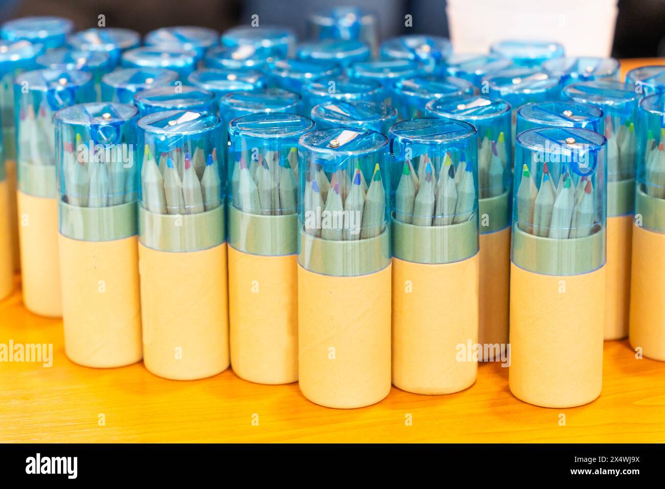 Small colored pencils in yellow cylinders equipped with sharpeners ...