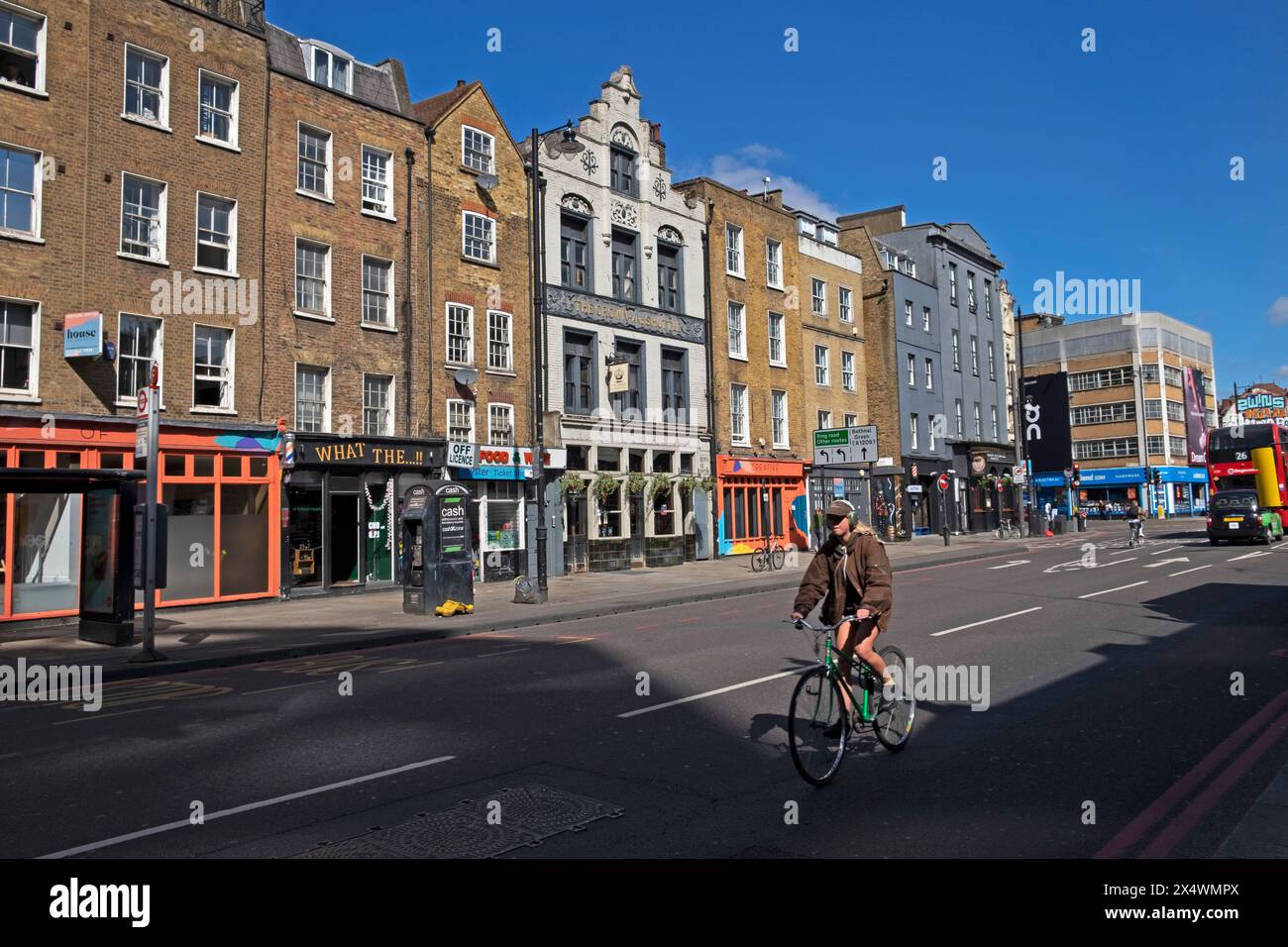 View of old buildings shops row of terraced flats exterior young woman ...