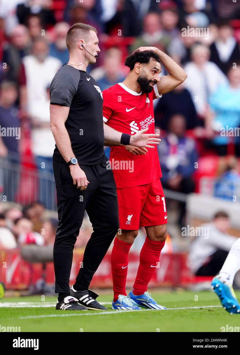 Liverpool's Mohamed Salah waits to return to the pitch after changing ...